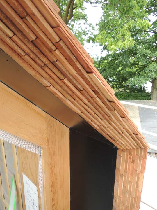 Houten shingles op aanbouw Rijksmonument